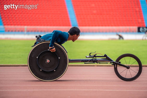 Asian young man para-athletes disabled practice handcycling in stadium ...