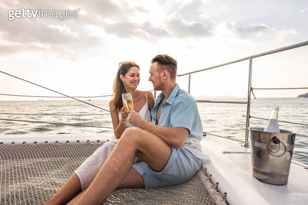 Caucasian romantic couple looking at beautiful view during yachting ...