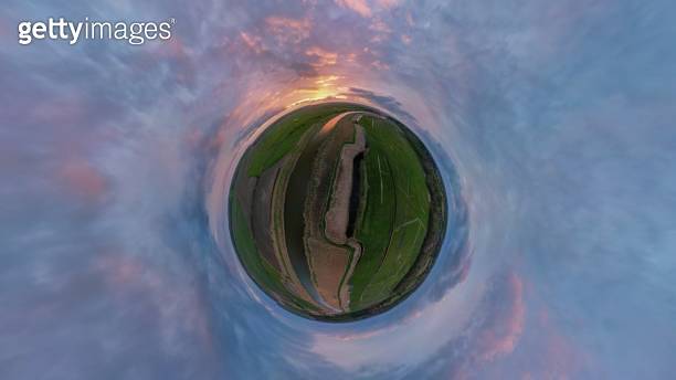A tiny planet view of spectacular sunset over the River Waveney at ...