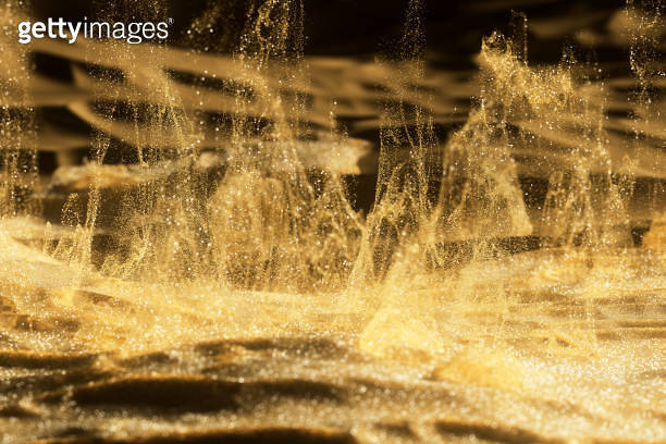 Sparkling sparkles form peaks and layered shapes of a light golden haze ...