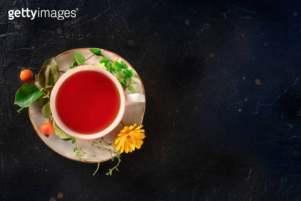 Tea with various ingredients and copy space. Tea with herbs, fruits ...