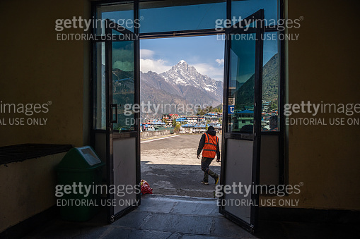Lukla airport look through airport terminal hub. Lukla is one of the ...