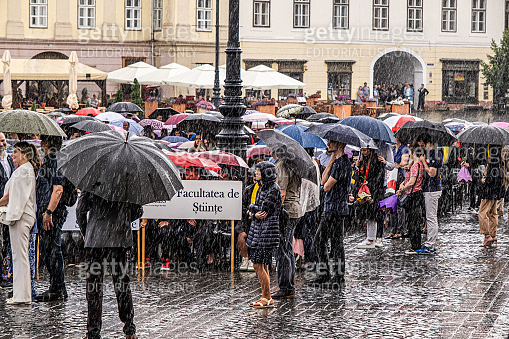 Graduation ceremony where students are throwing their caps into the air ...