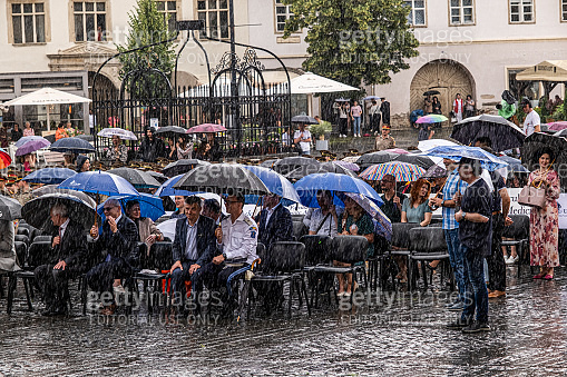 Graduation ceremony where students are throwing their caps into the air ...