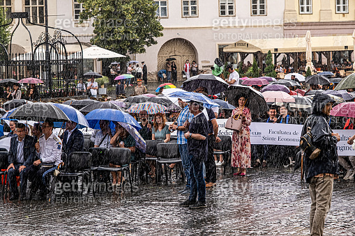 Graduation ceremony where students are throwing their caps into the air ...