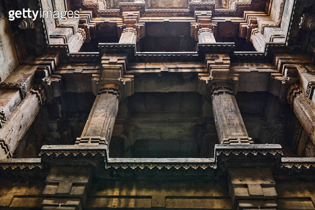 Upward view revealing the grandeur of stone-carved columns and the ...
