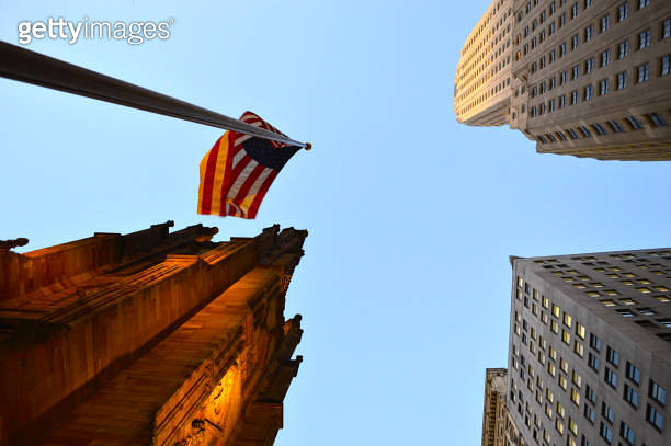 american flag flies in the breeze between high - rise buildings 이미지 ...