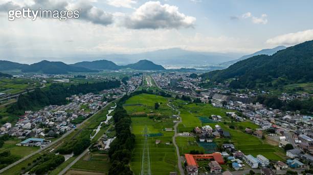 Aerial shot of a rural community and farms of Nagano, summer in Japan ...