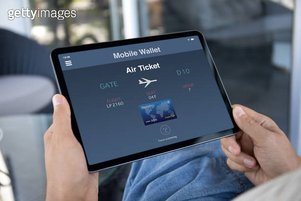man hands hold computer tablet with airplane ticket application ...