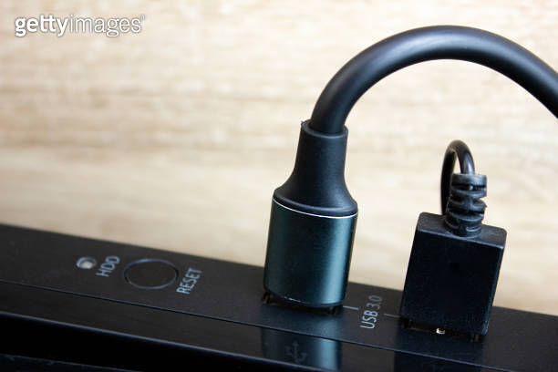 USB cable connection to a computer. Hard disk drive, USB cable data ...