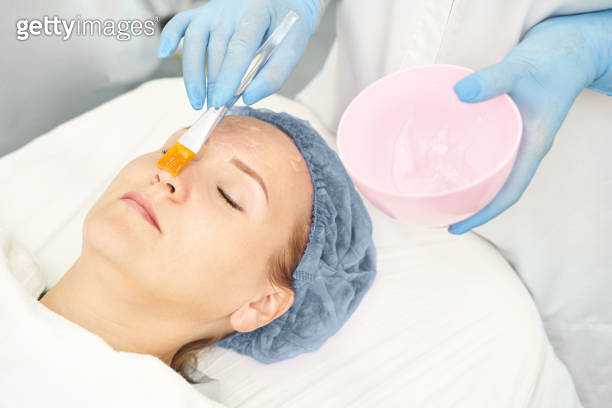 Dermatology anti age treatment. Applying gel with brush. Microcurrent ...