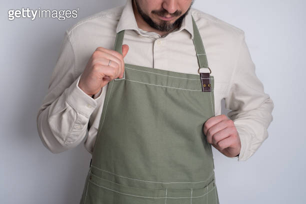 A man in a kitchen apron. Chef work in the cuisine. Cook in uniform ...