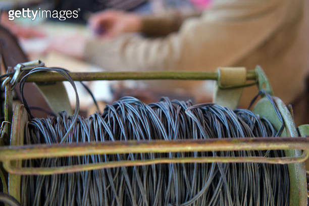 Spool of communication wire on a metal reel. Field communication ...