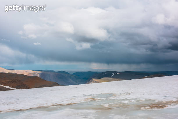 Dramatic alpine top view from flat sloping glacier on precipice edge to ...