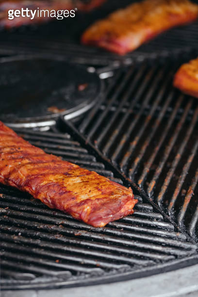 Mouthwatering Rack of Ribs on Round Grill. Glazed Barbecue Meat Over ...