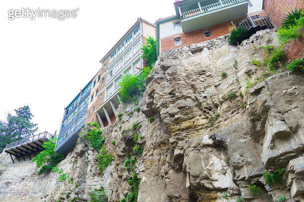 Residential buildings with wooden colorful carved balconies on high ...