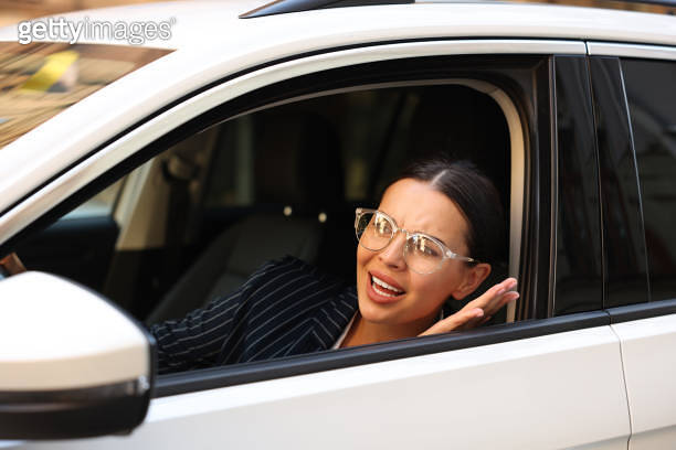Stressed driver screaming in her car. Stuck in traffic jam (1932641372 ...
