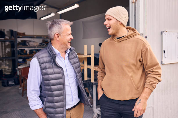 Smiling Manager And Male Worker Standing In Doorway Of Concrete ...