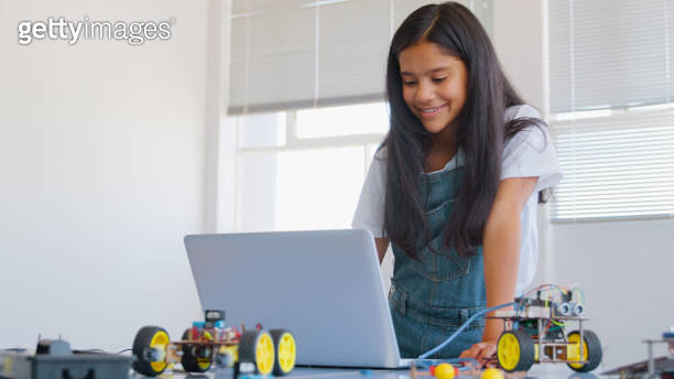 Female Student Building And Programming Robot Vehicle In After School ...