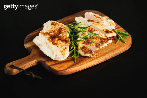 Semi-finished chicken fillets,lightly fried,on a dark background with ...
