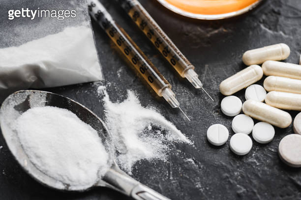 Narcotic substances in spoon, dope powder in transparent plastic bag ...