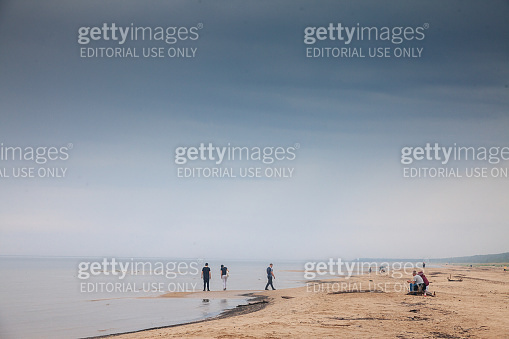 people standing and admiring Panorama of Garciems beach (Garciema ...
