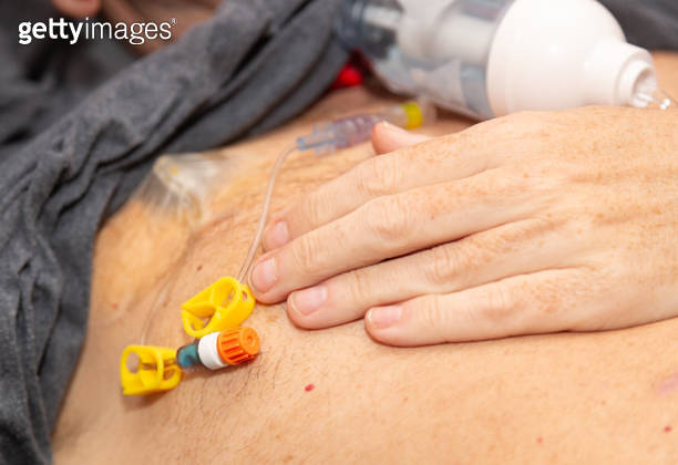 A hand with delicate finger touches a chest, creating a comforting ...
