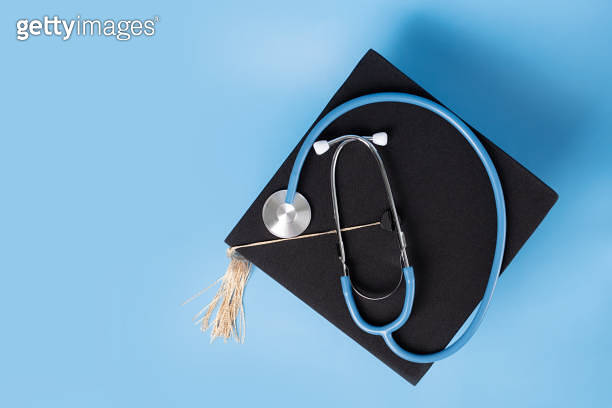 Medical education, graduation cap and doctor's stethoscope, student ...