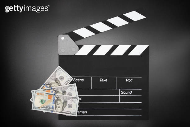 Cinema clapper board and money, film production expenses, Hollywood ...