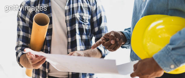 Colleagues architect, contractor and construction engineer are ...