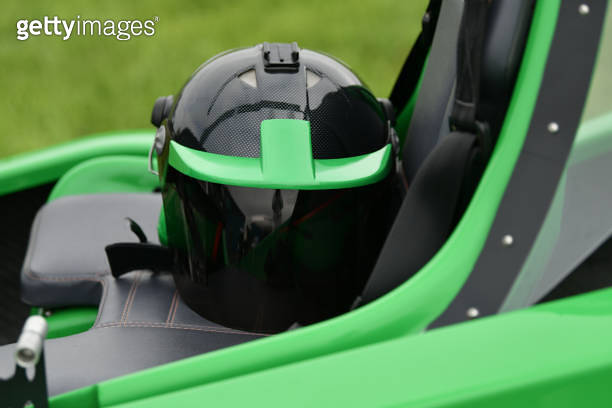 Helmet on a two-seater green gyrocopter at the airfield 이미지 (2056880148 ...