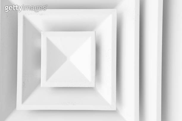 White ceiling ventilation grille with square diffusors, close-up ...