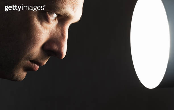 Close up profile portrait of young man staring at the light (2164405702 ...