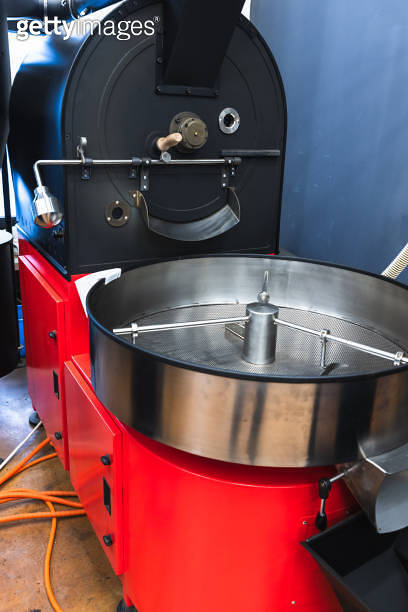 Coffee roaster in a coffeehouse, vertical photo of industrial roastery ...