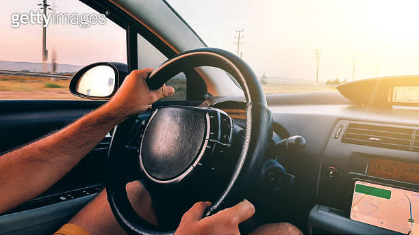 Man driving car on highway. Hands on the wheel when driving at high speed from inside the car ...