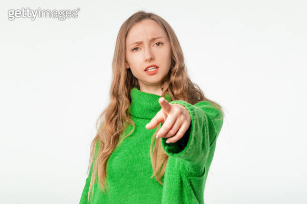 It's your fault. Portrait of disappointed young woman frowning ...
