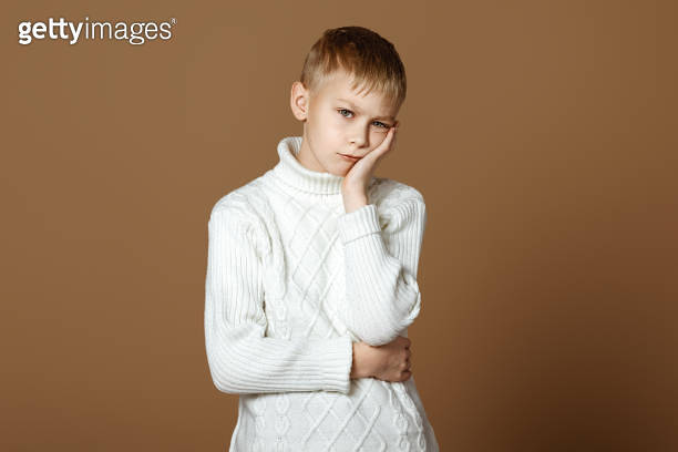 Bored teen boy looking annoyed, unamused and uninterested, leaning face ...