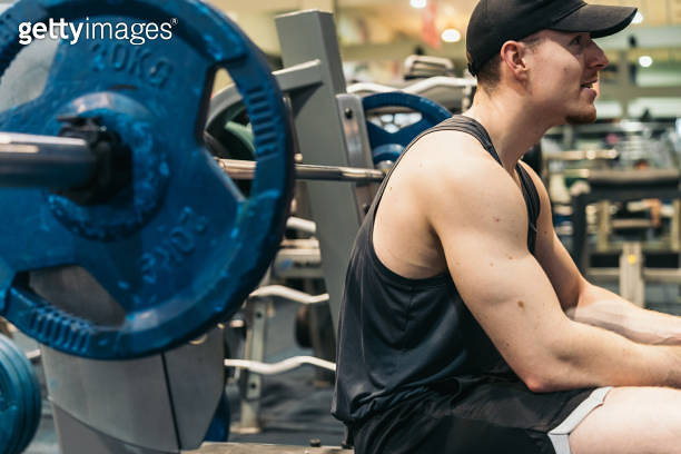 Side View of Smiling Red-haired Athlete Resting on Bench Press. Red ...