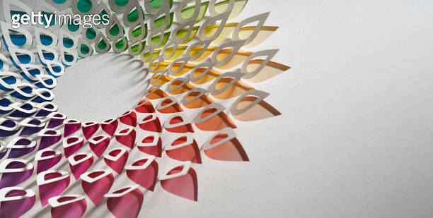 Colorful circular paper artwork with gradient drop-shaped cutouts ...