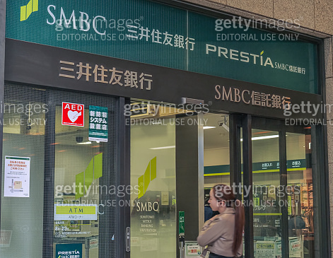 Customer entering the branch office of SMBC bank in Kyoto, Japan ...