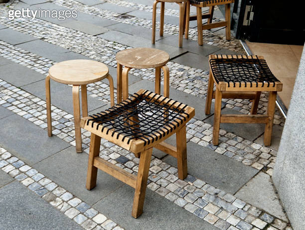 Cafe terrace with a wooden table and a flower in a tin pot. There must ...