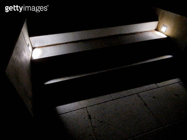 lighting of stairs and steps on the concrete wall on the side of the ...