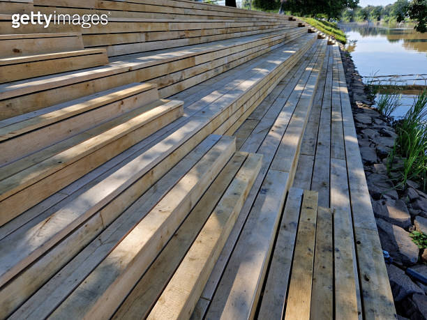 a floating jetty for mooring ships is fixed with metal rods on hinges ...