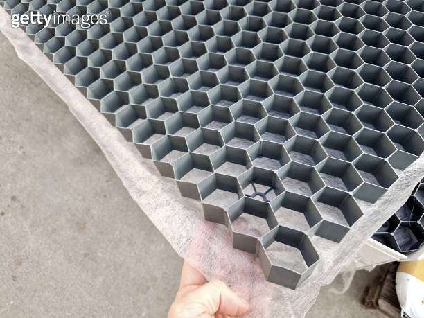 hexagonal grid pattern with geotextile at the bottom. it is very ...
