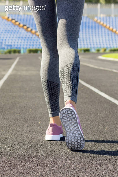 Ready to go. Close up photo of shoe of female athlete on the starting ...