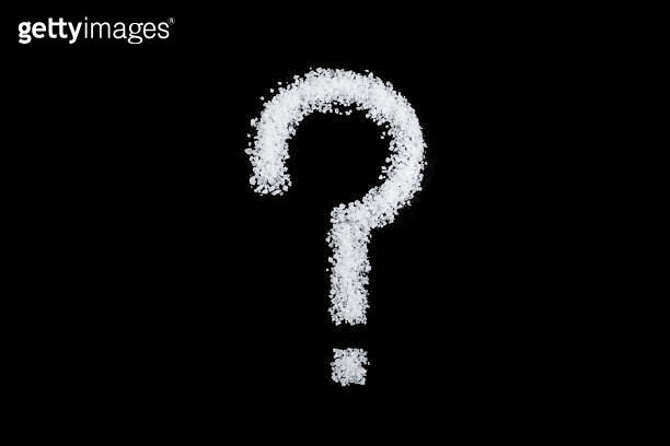 Question mark symbol made with rock salt grain, on black background ...