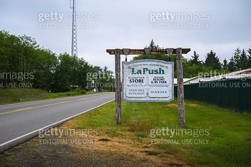 Welcome sign for La Push with directions to local amenities on a cloudy ...