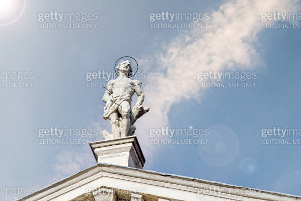 Statue of St Sebastian wounded by arrows on the pediment's apex of the ...