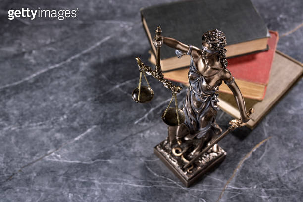 Lady Justice with books in the background on gray marble 이미지 ...