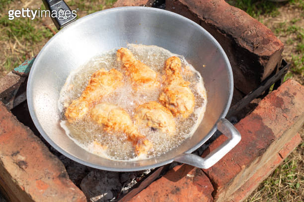 Chicken legs in batter are fried in a wok. Cooking outside 이미지 ...